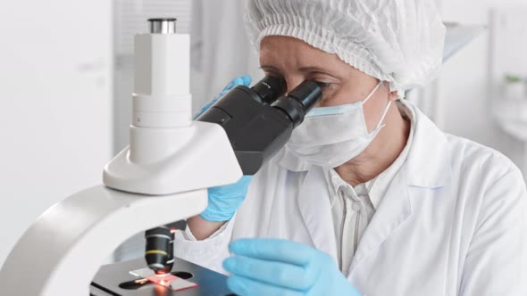 Nurse Looking through Microscope, Stock Footage | VideoHive