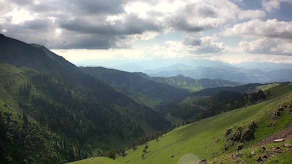 A Mountain Village in the Meadows of the Wooded Deep Green Valley ...