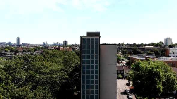 Aerial footage of a random apartment building in London. Drone lifts up ...
