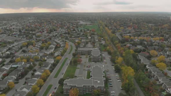 Rising aerial footage going straight towards a large sunset over a ...