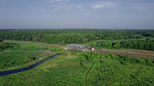 Railway Bridge in Countryside Passing Above Small River, Stock Footage