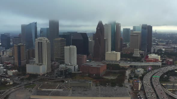 This video is about an aerial of downtown Houston on a rainy and cloudy ...