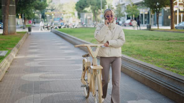 Female Cyclist Speaking on Cellphone, Stock Footage | VideoHive