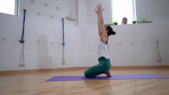 Woman showing Cactus and Eagle Arms poses on yoga mat, Stock Footage