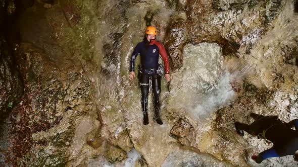 Aerial view of a woman lying on rock surrounded by water in Soca river ...