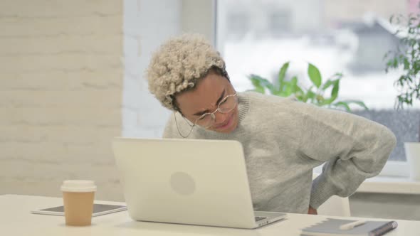 African Woman Having Back Pain While Using Laptop in Office, Stock Footage