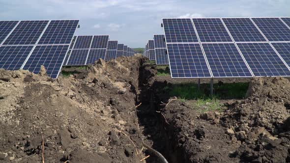 Laying Cable in the Trenches Between the Rows of Solar Panels Power ...