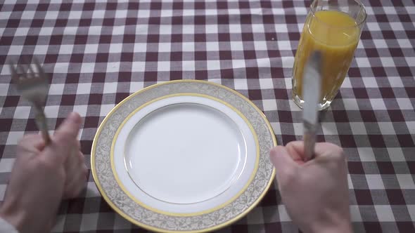 Man's Hand Knocking on the Table with His Fists with Fork and Knife ...
