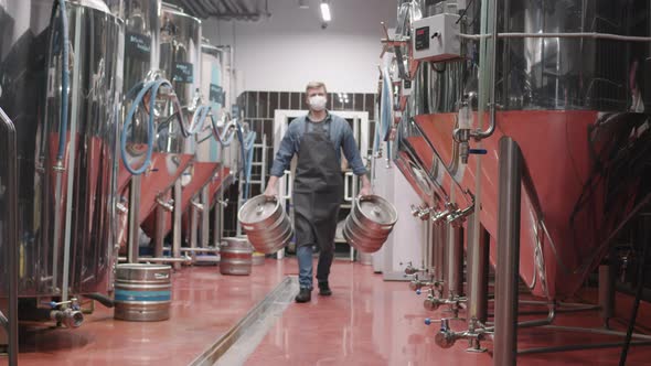 Man Carrying Metal Barrels At Brewery, Stock Footage | VideoHive