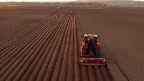 Contemporary Tractor Drags Plug Making Furrows on Soil in Field at ...