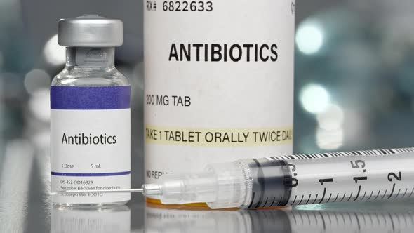 Antibiotics in vial and pill bottle in medical lab with syringe, Stock ...