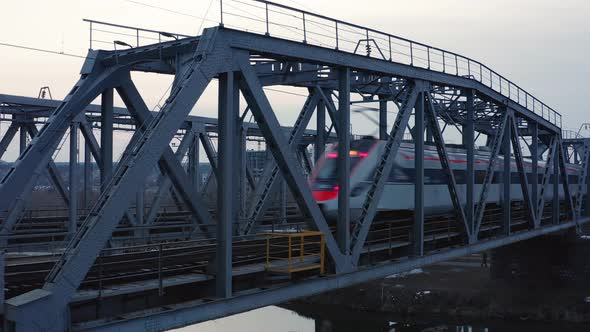 High speed train passing through railway bridge. Intercity passenger ...