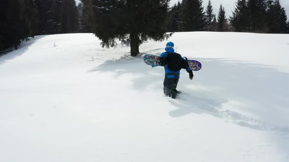 Aerial View of a Snowboard Going Uphill Near the Village at Sunset ...