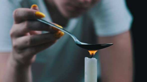 Young Woman Drug Addict Cooking Drugs in Spoon on Candle Flame, Stock ...