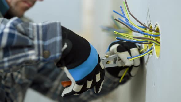 Man Cuts Wires In Electrical Outlet., Stock Footage | VideoHive