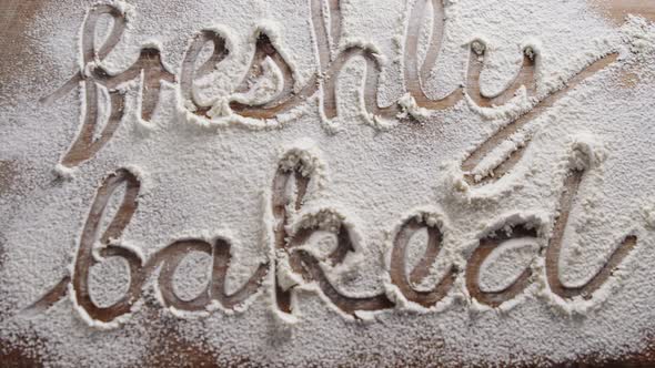 The word freshly baked written on sprinkled flour, Stock Footage ...