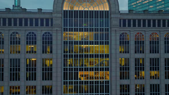 Pull Back Shot of Illuminated Interior of High Rise Commercial Building ...