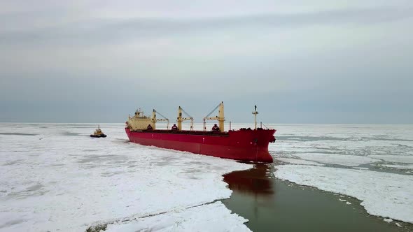 Aerial Above Epic Huge Steel Icebreaker Breaks Ice By Bow of Ship and ...