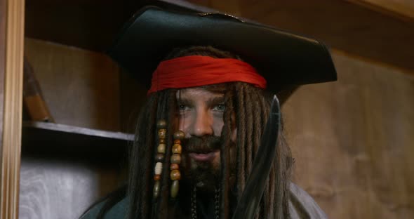 Crazy Pirate Captain Shakes with Saber Against Wooden Racks, Stock Footage