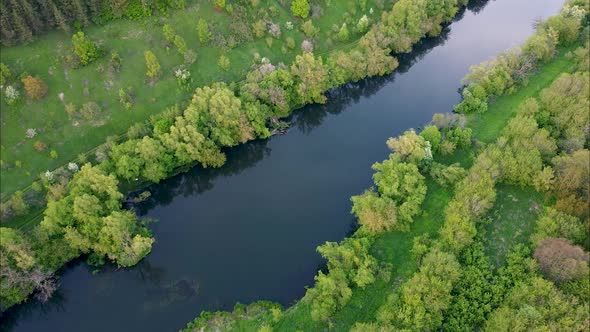 View of the river from above. Flight over water and forest trees from a ...