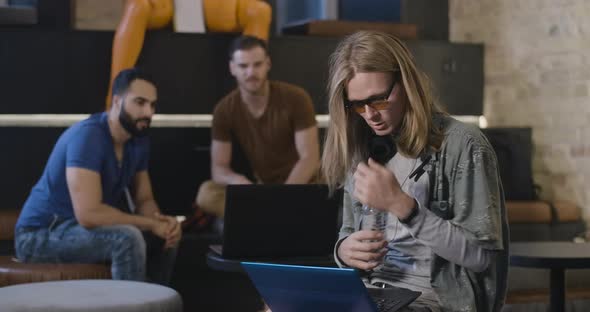 Football Fans Distracting Concentrated Young Man Using Laptop and ...