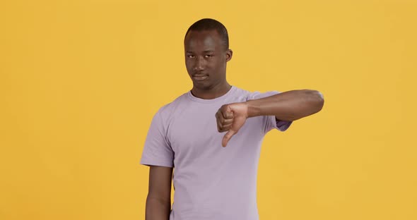 Grumpy African American Guy Showing Thumb Down Gesture, Stock Footage