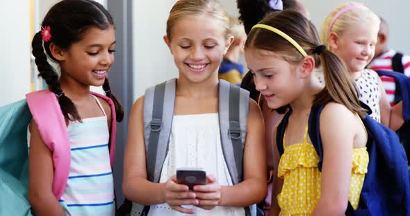School kids using mobile phone in corridor, Stock Footage | VideoHive