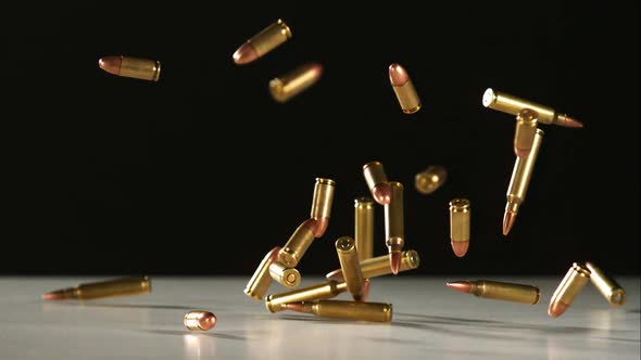 Bullets falling bouncing in ultra slow motion 1500fps on a reflective ...