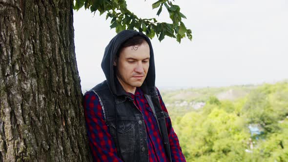 Young man standing near tree in nature. , Stock Footage | VideoHive