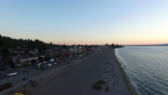 Sweeping aerial shot of Alki Beach in West Seattle during a summer ...
