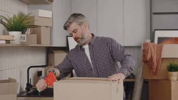 Man is Taping a Box in Home, Stock Footage | VideoHive