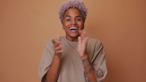Surprised African Woman Keeping Mouth Open Spreading Hands Over Brown