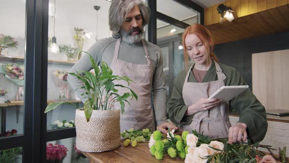 Flower Shop Workers Arranging Flowers Together, Stock Footage | VideoHive