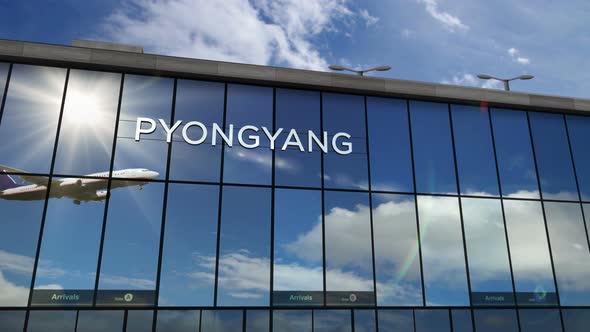 Airplane landing at Pyongyang North Korea airport mirrored in terminal ...