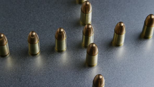 Cinematic rotating shot of bullets on a metallic surface - BULLETS ...