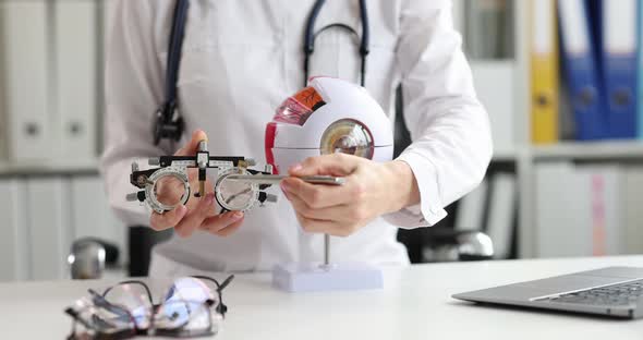 Doctor Showing Glasses for Checking Vision and Artificial Model of ...