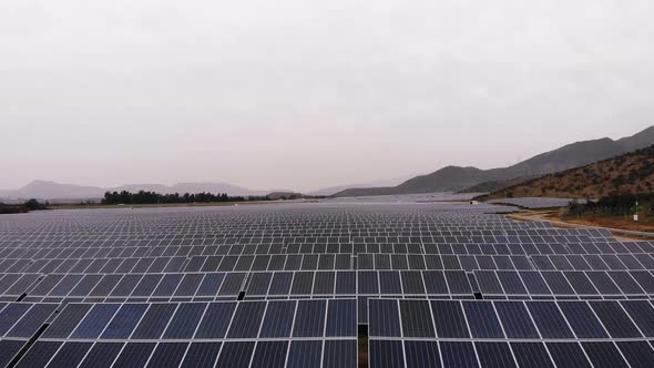Aerial Shot going forward barely above ground over Solar panels in ...