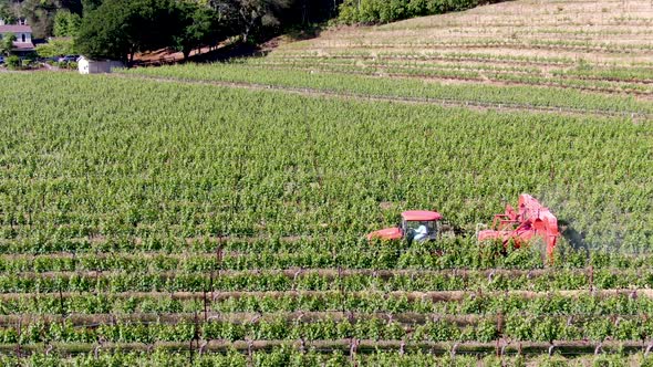 Farm Tractor Spraying Pesticides and Insecticides Herbicides Over Green ...