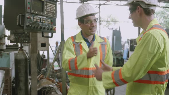 Two maintenance man and partner work with system of machine in ...