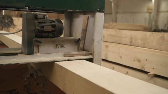Worker Gives the Desired Shape To a Wooden Beam on Planer Machine ...