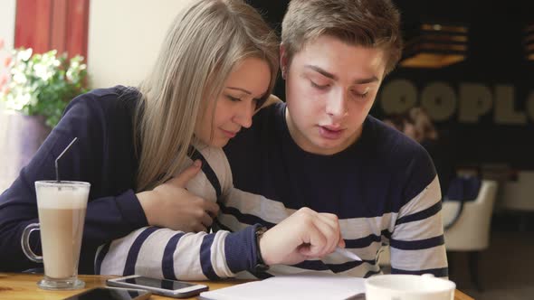 Young Man Writing a Letter or Doing His Homework in a Cafe, Stock Footage