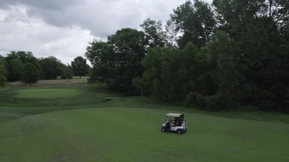 following golf carts driving on golf course, aerial drone, Stock Footage