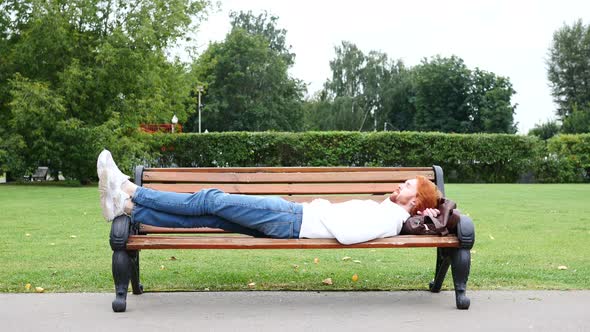 Sleeping Tired Man with Red Beard and Hairs in Park on Bench, Stock Footage