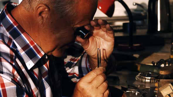 Goldsmith examining diamond, Stock Footage | VideoHive