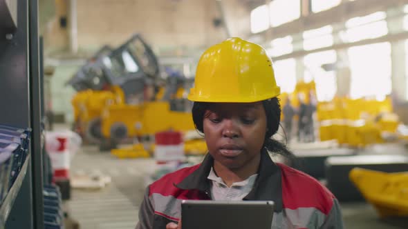 Female Factory Supervisor Working on Digital Tablet, Stock Footage