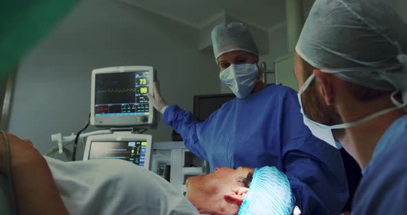 Front view of Caucasian female surgeon operating pregnant woman in ...