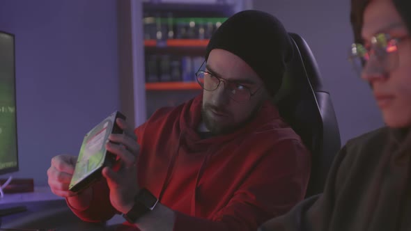 Two Multiethnic Hackers Examining Hard Disk, Stock Footage | VideoHive