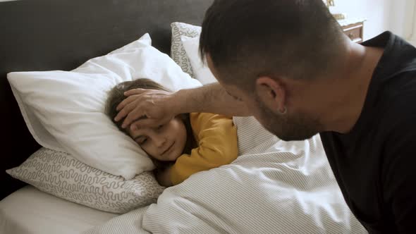 Solicitous Father Checking Forehead of Sick Daughter, Stock Footage