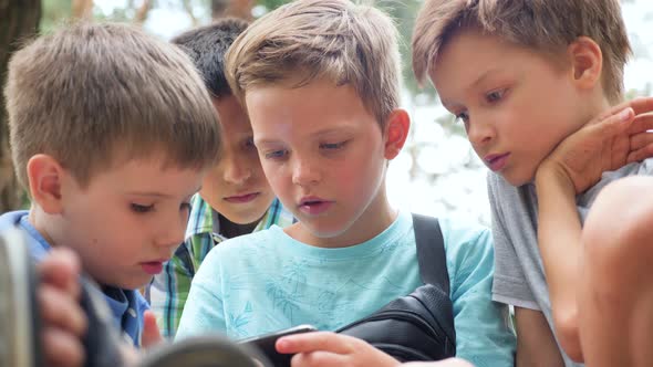 Three Boys Playing Video Game. Three Brothers with Gadget. Faces of ...