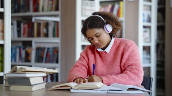 Female Student Doing Homework and Listening to Music, Stock Footage